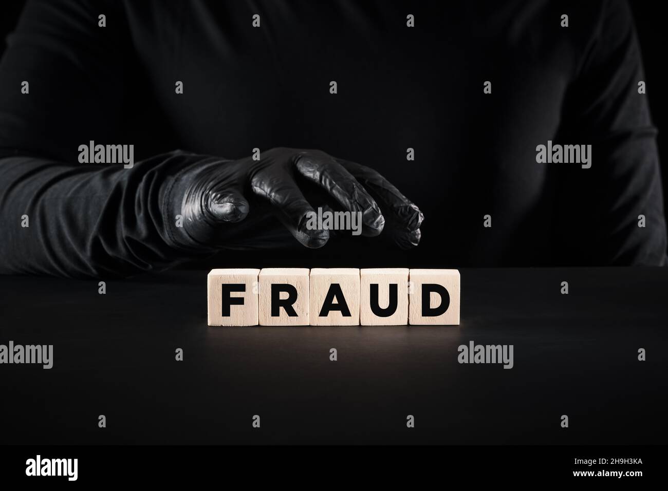 Fraud crime concept. Criminal hand wearing black gloves is over the ...