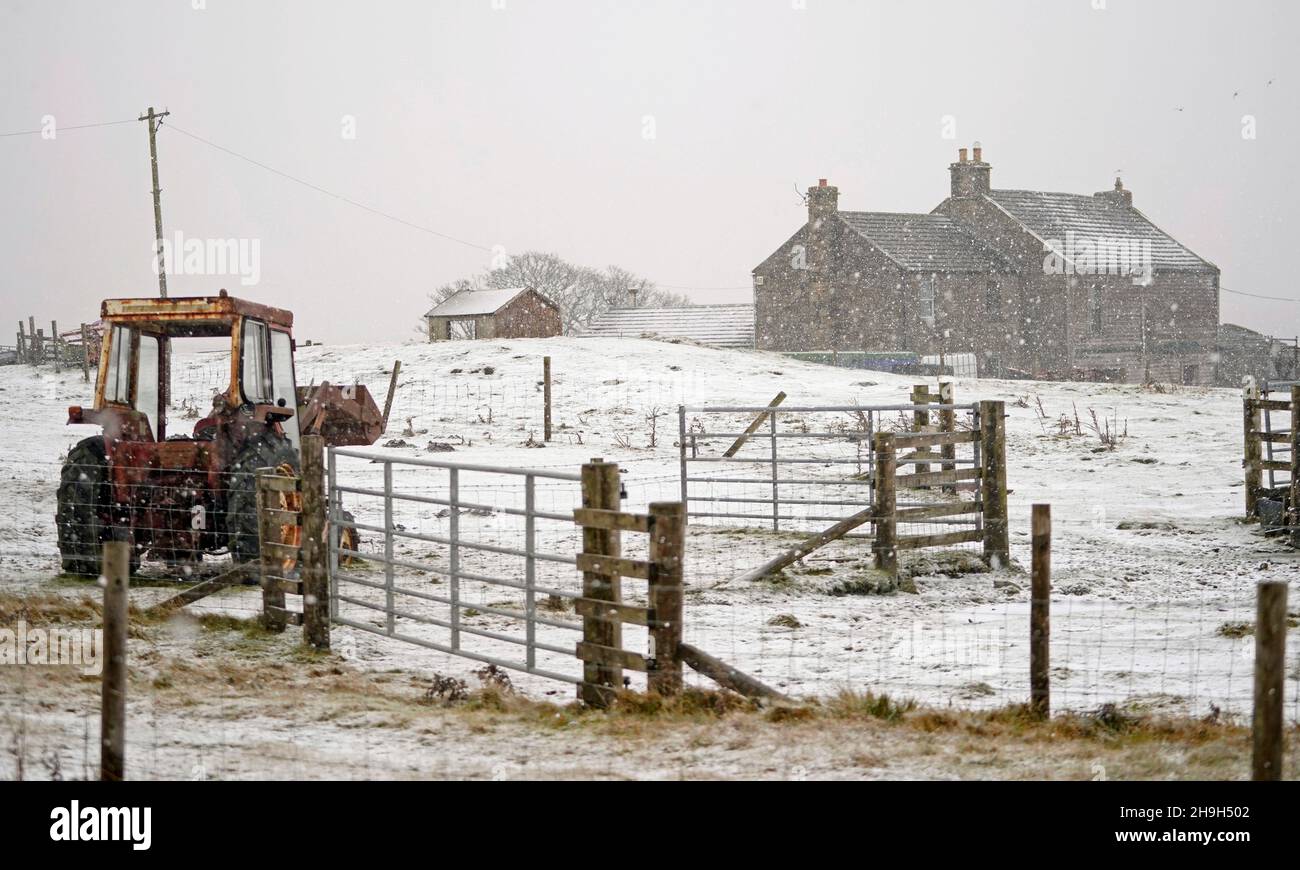 Snow falls near a farm building on the A66 between Stainmore and Bowes ...