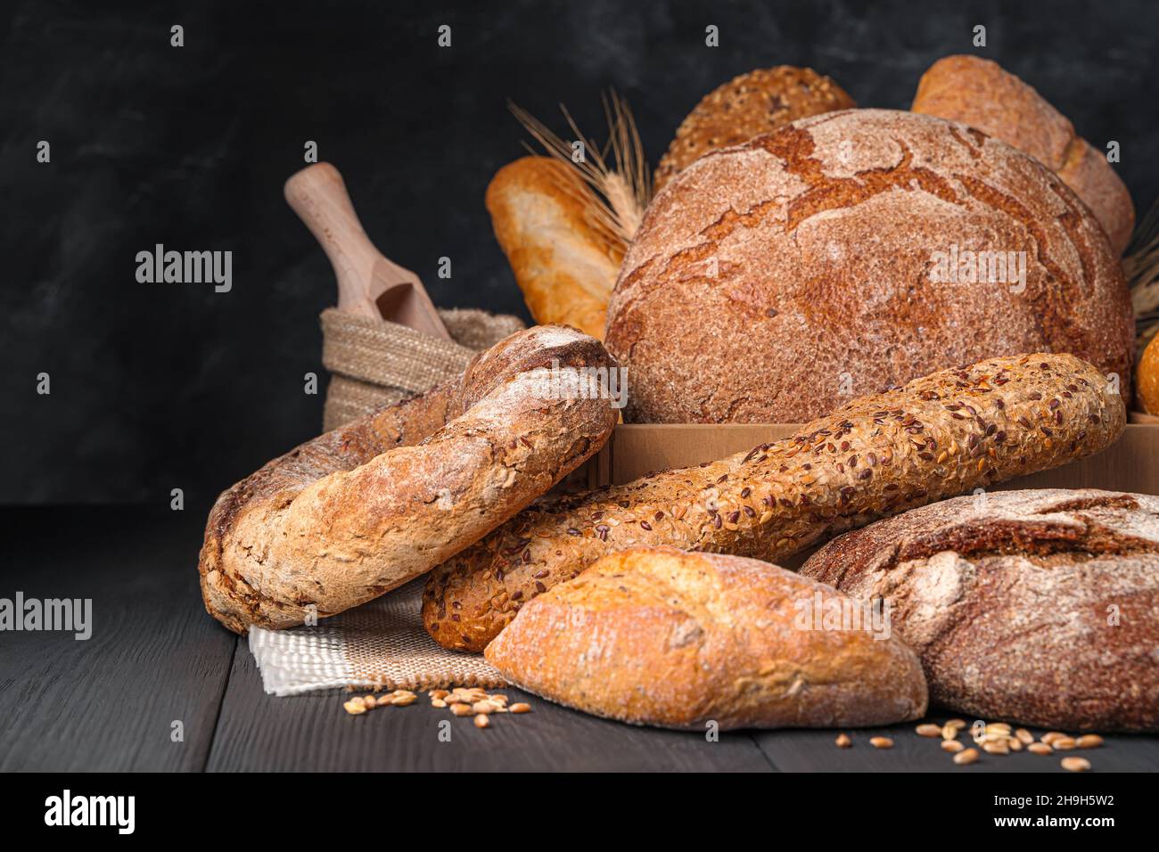 Rye and wheat bread of different types on a dark background. Bread ...