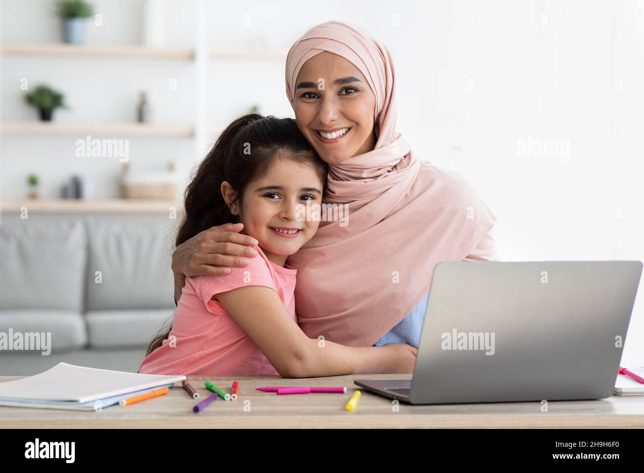 Happy Muslim Woman In Hijab And Her Little Daughter Posing At Home ...