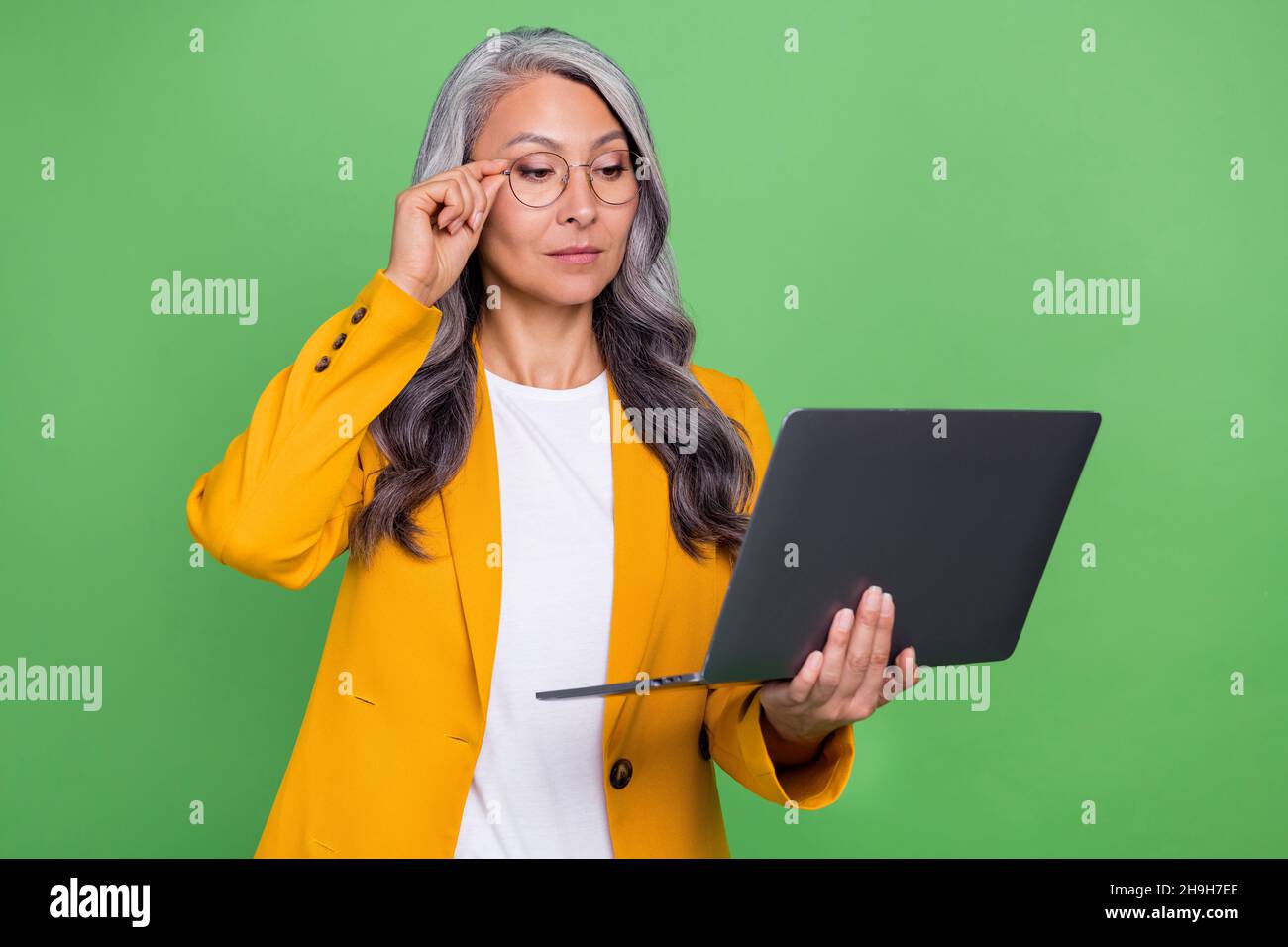 Photo of mature woman look laptop report eyeglasses manager banker ...