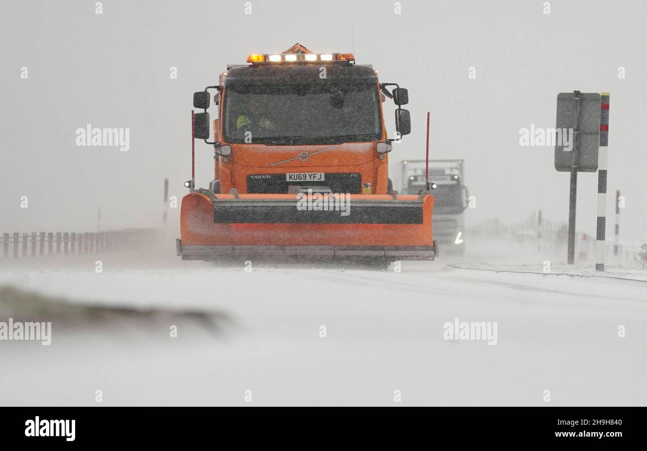 A snowplough makes its way through falling snow on the A66 between ...