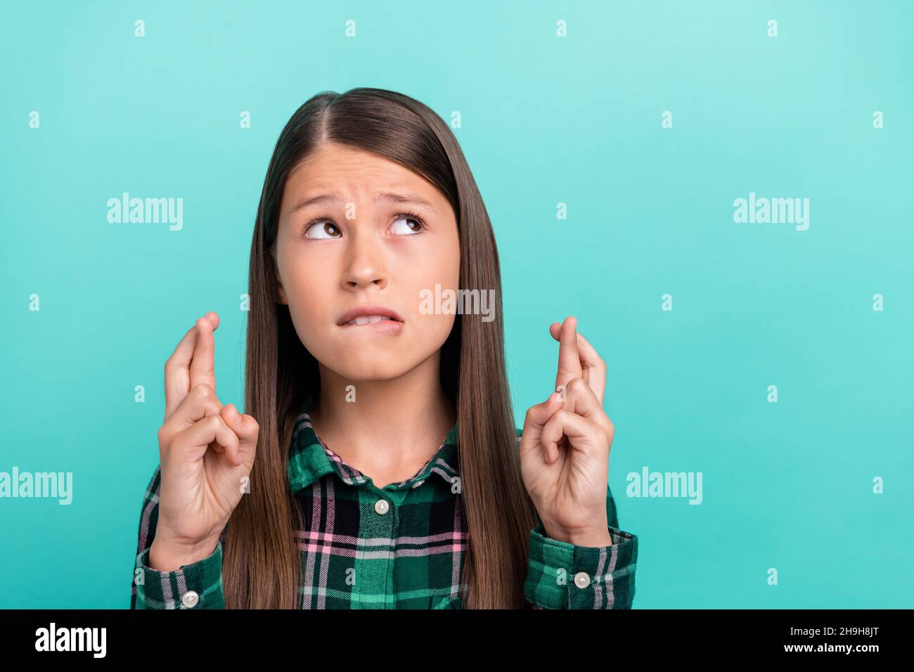 Photo of unhappy upset school girl dressed checkered clothes biting lip ...