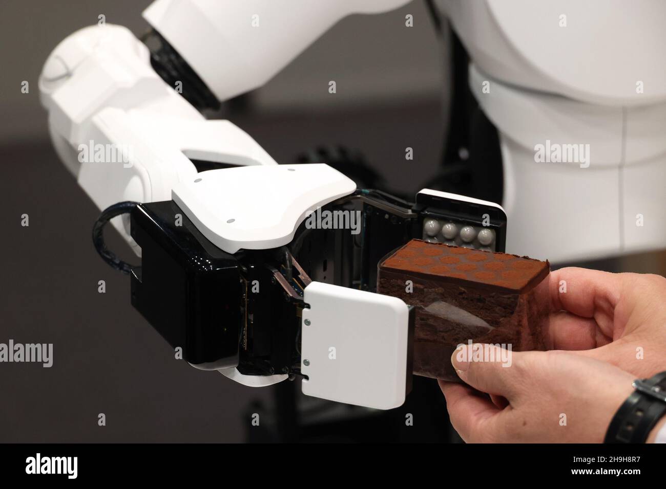 Tokyo, Japan. 7th Dec, 2021. Japanese electronics giant Sony's humanoid robot grips a piece of ...