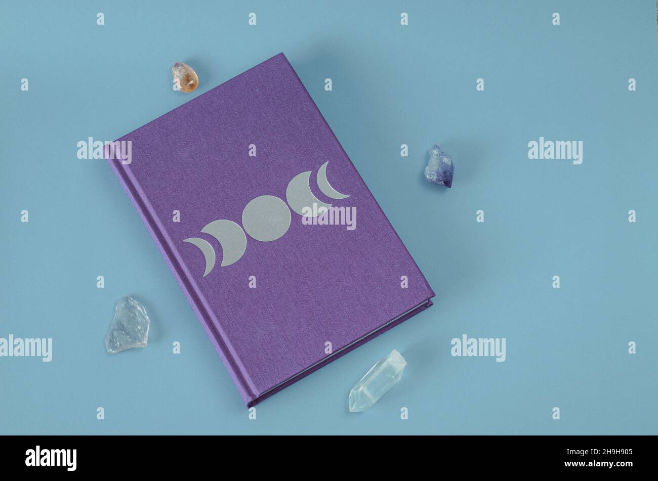 Purple moon phases diary, chakra stones for crystal healing on blue ...