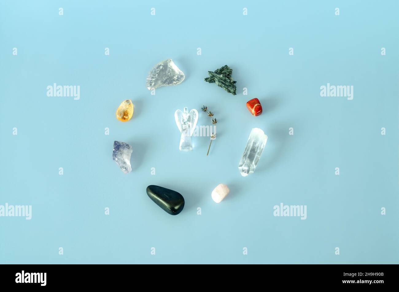 Minimalist flat lay of healing crystals circle with angel in the middle ...