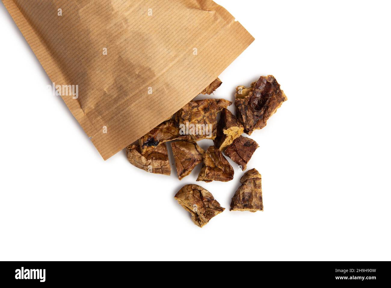 Dog food - dried beef lung, poured out of the package isolated on white ...