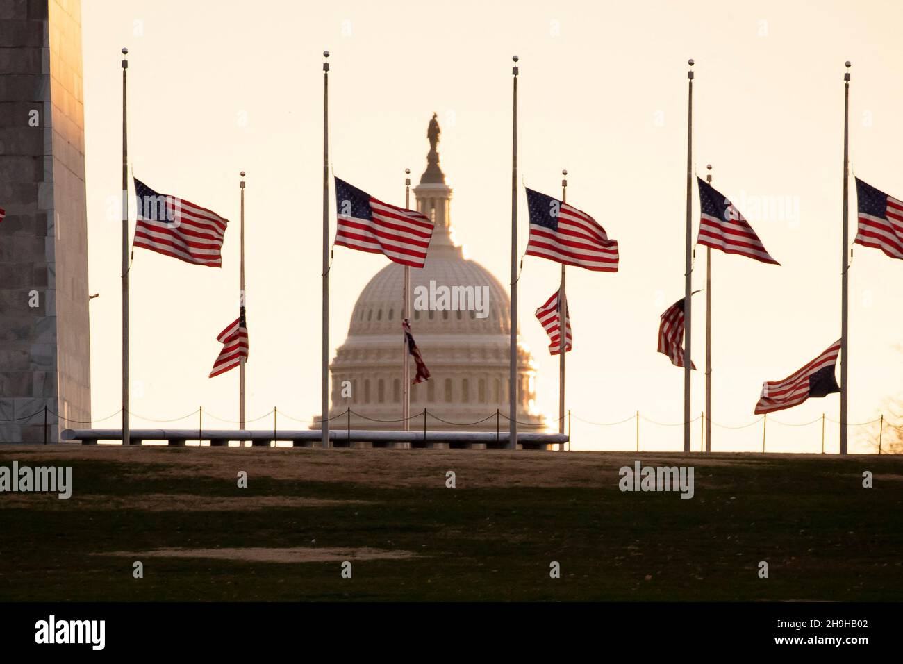 US national flags fly at half-staff at the base of the Washington ...