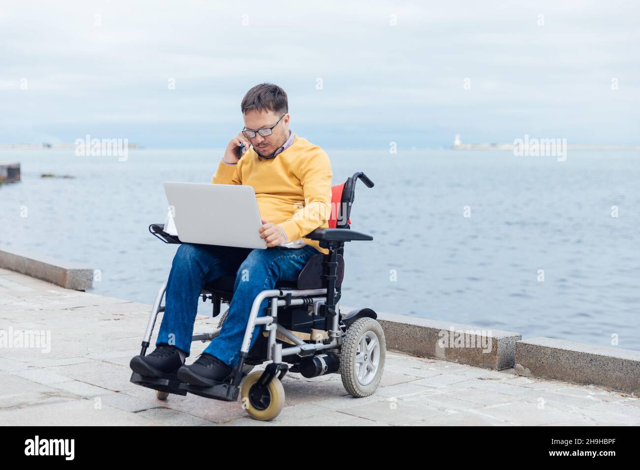 a man with a disability in a disabled working business remotely Stock ...