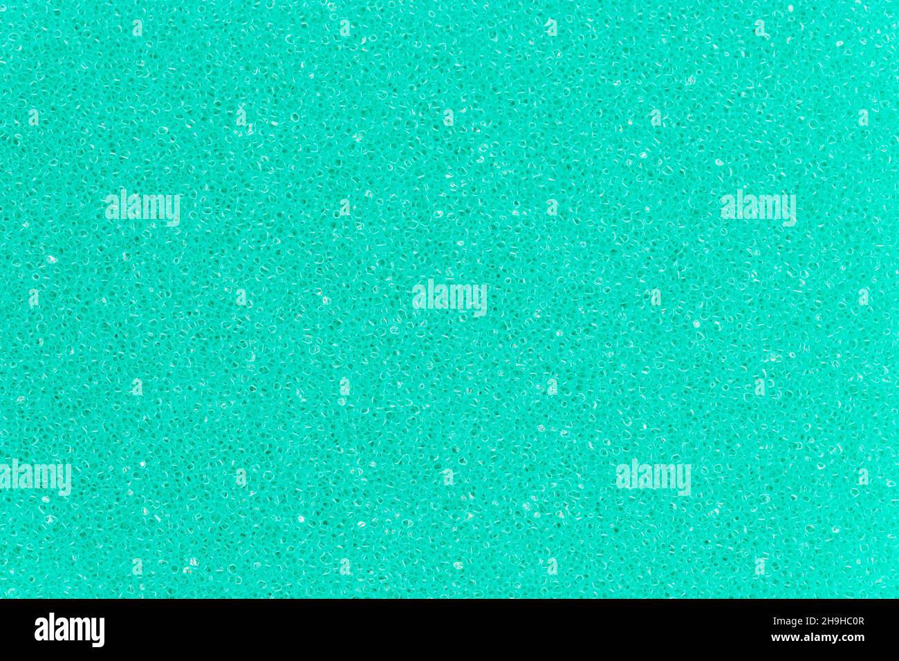 Turquoise color foam sponge porous texture background. Extreme close-up ...