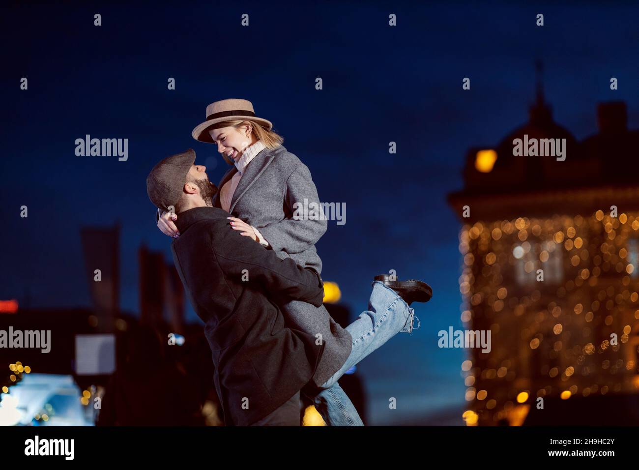 Romantic couple hugging on the street at night. Young affectionate ...