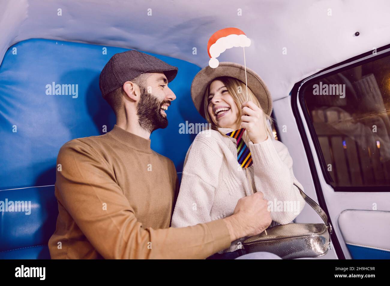 Romantic goofy couple having fun with the photo booth. A young happy ...
