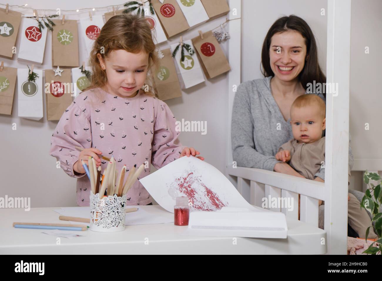 toddler child writing Christmas letter and doing advent calendar tasks ...