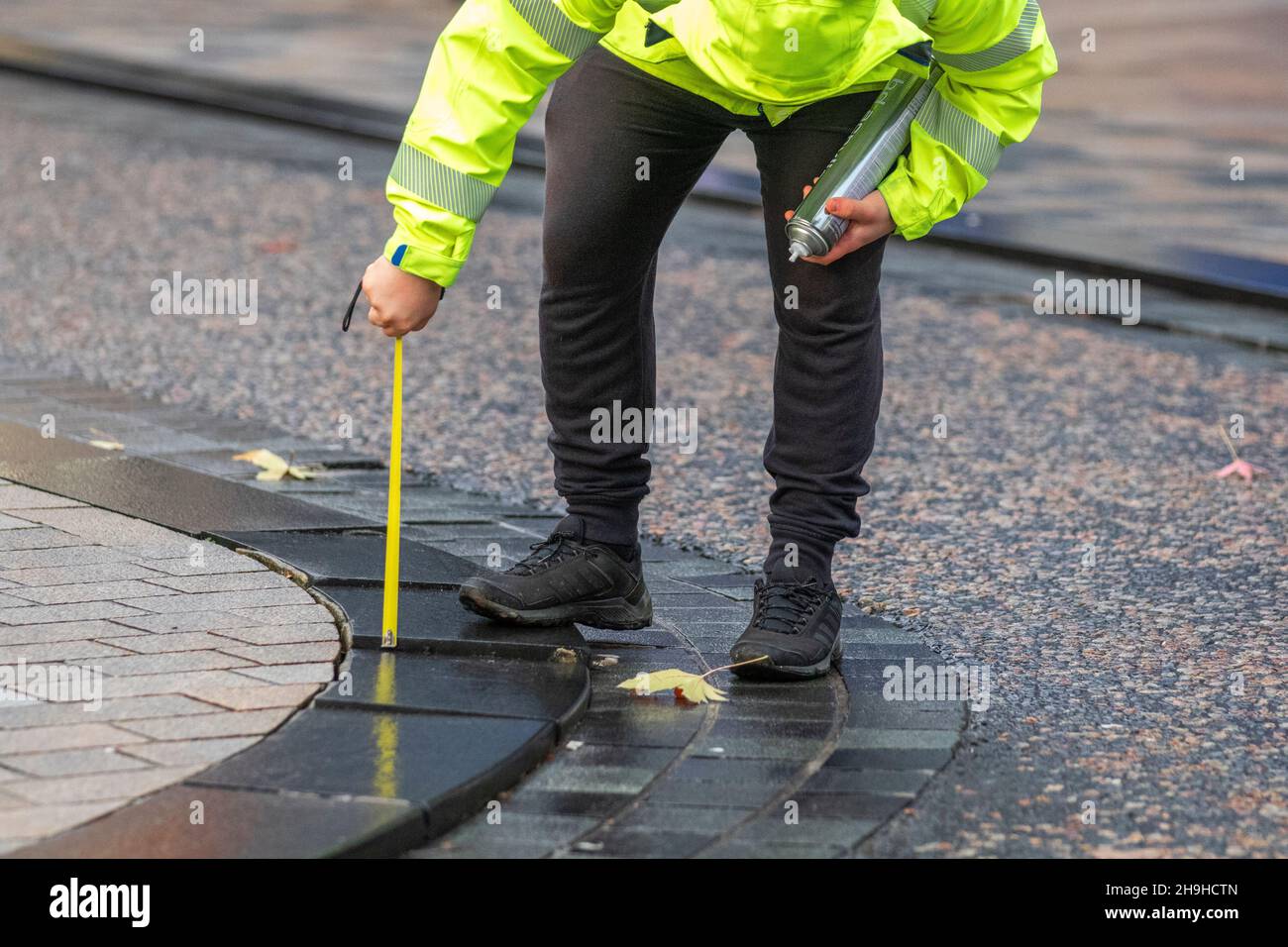 Preston Council workmen measuring pavement displacement for trip hazard ...