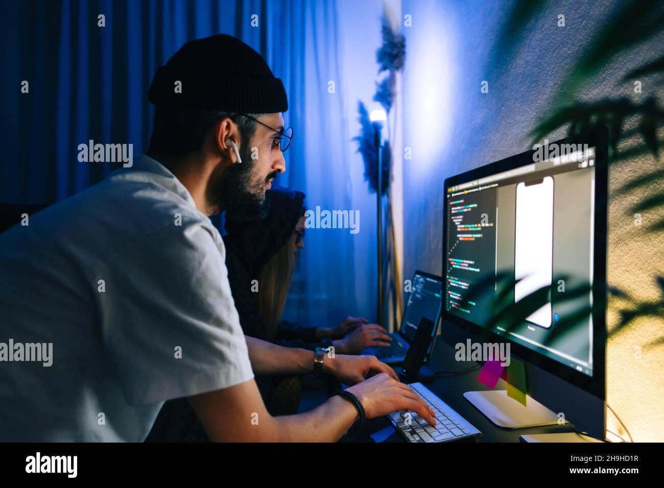 Mobile developers team writes program code on a computer, programmers ...