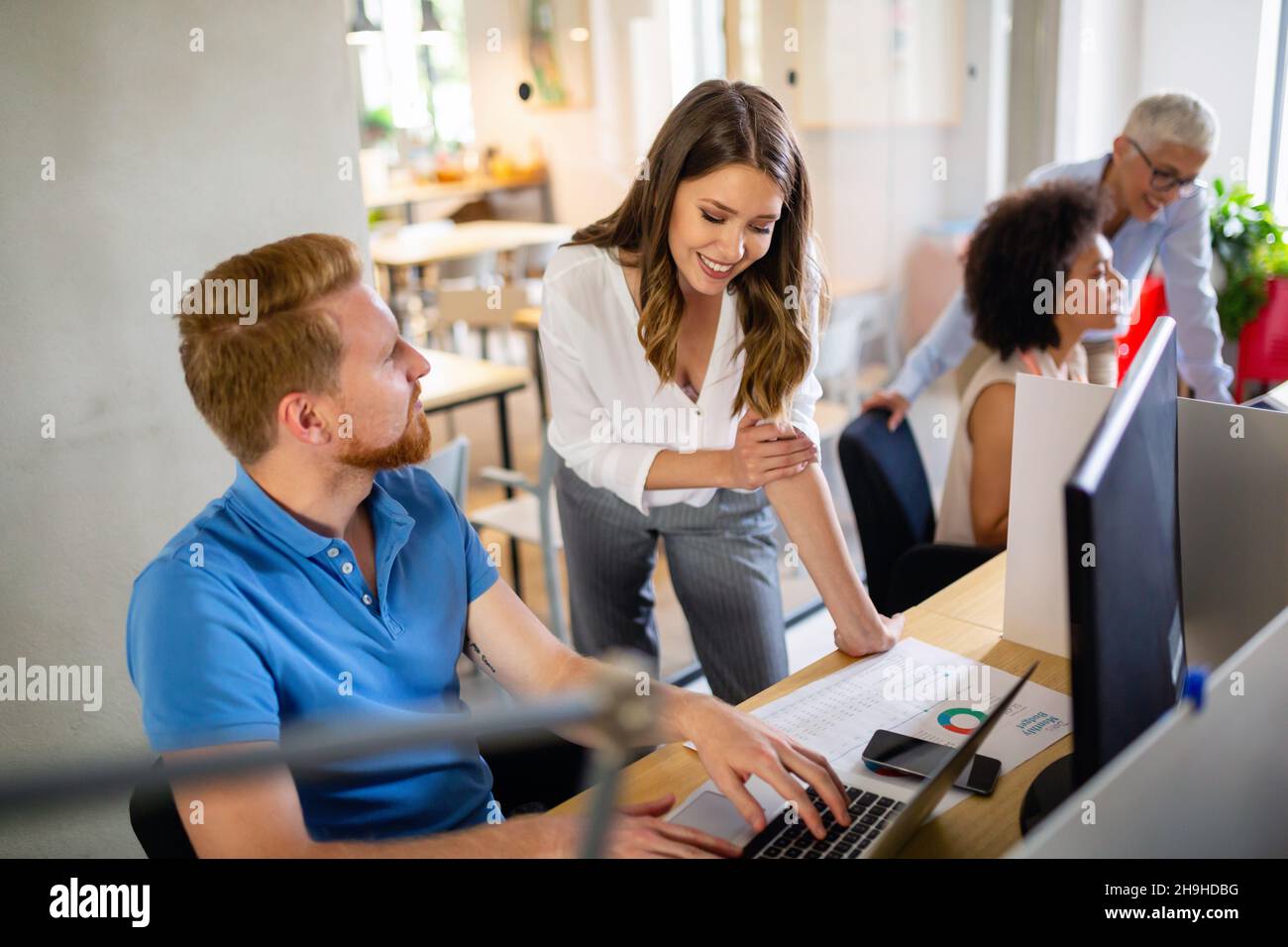 Group of software engineers working developing applications together in ...