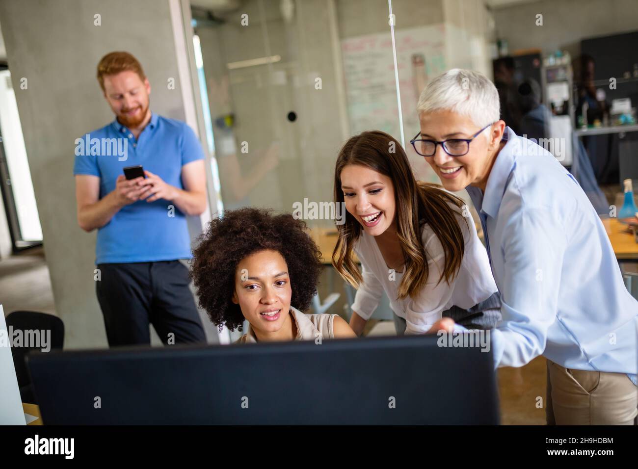 Group of software engineers working developing applications together in ...