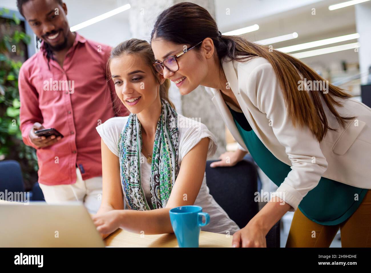 Group of software engineers working developing applications together in ...