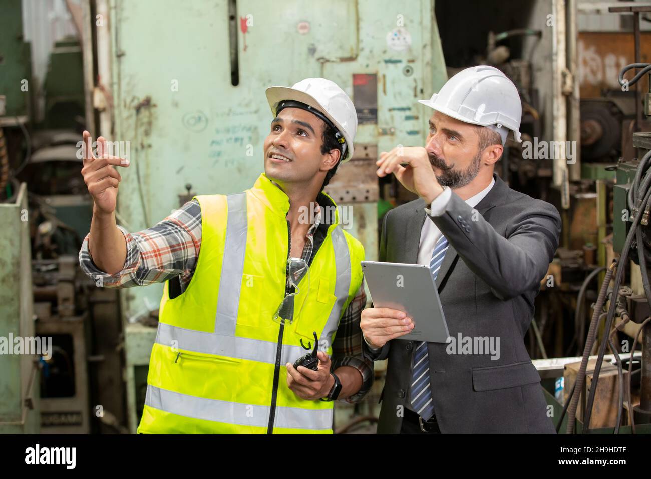 Hard-working engineer holding digital tablet in hands while working in ...