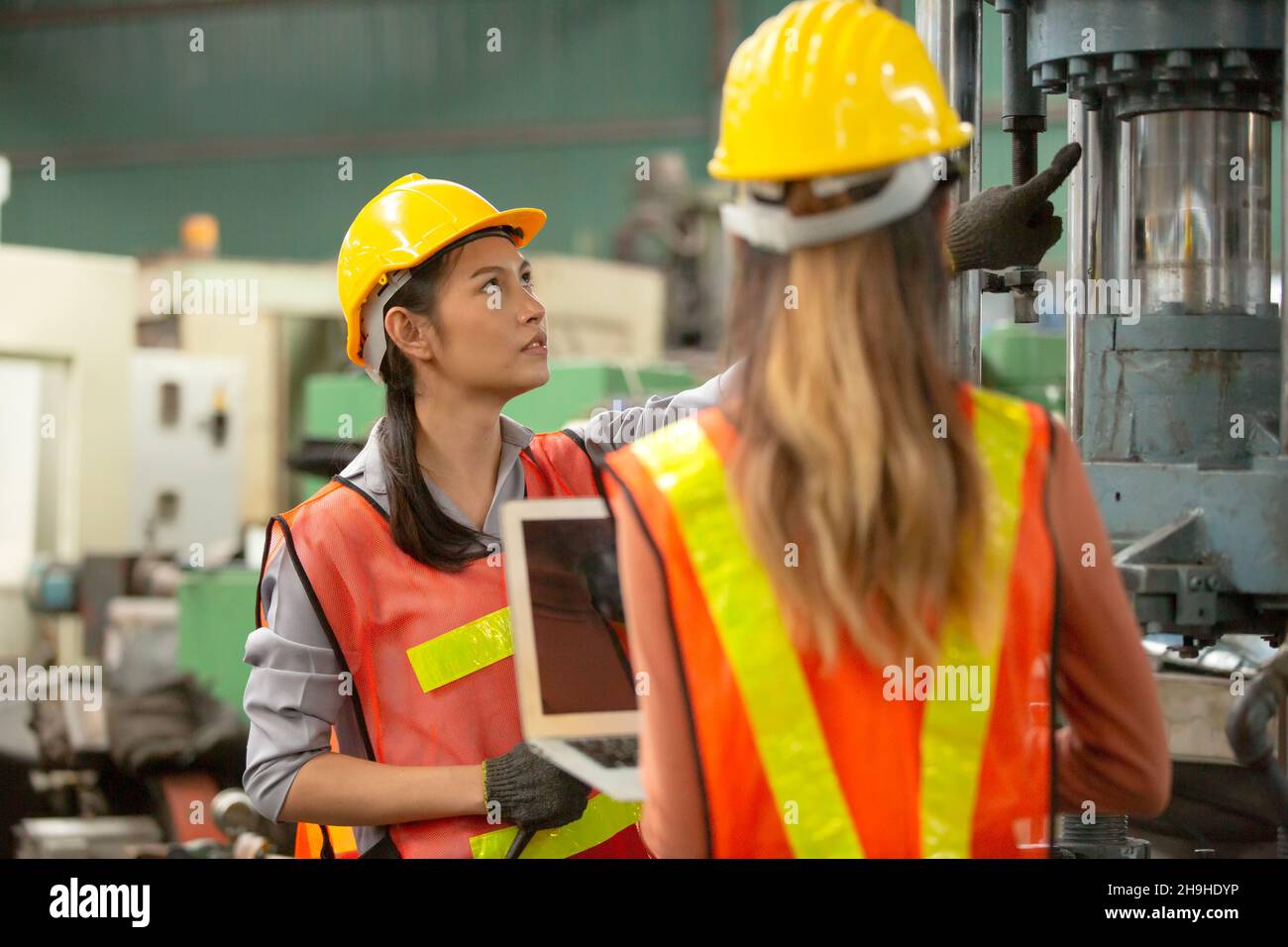 Hard-working engineer holding digital tablet in hands while working in ...