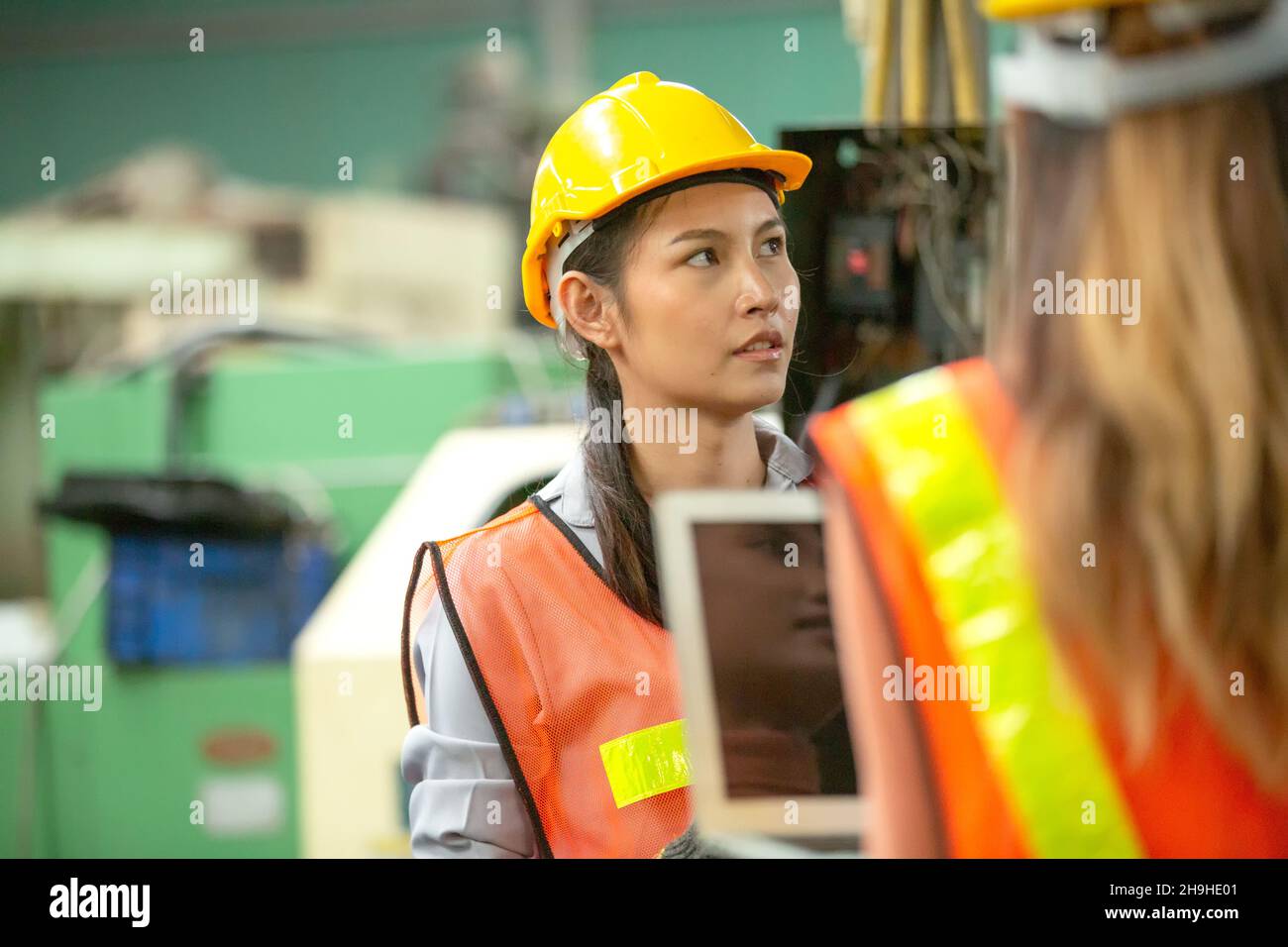 Hard-working engineer holding digital tablet in hands while working in ...