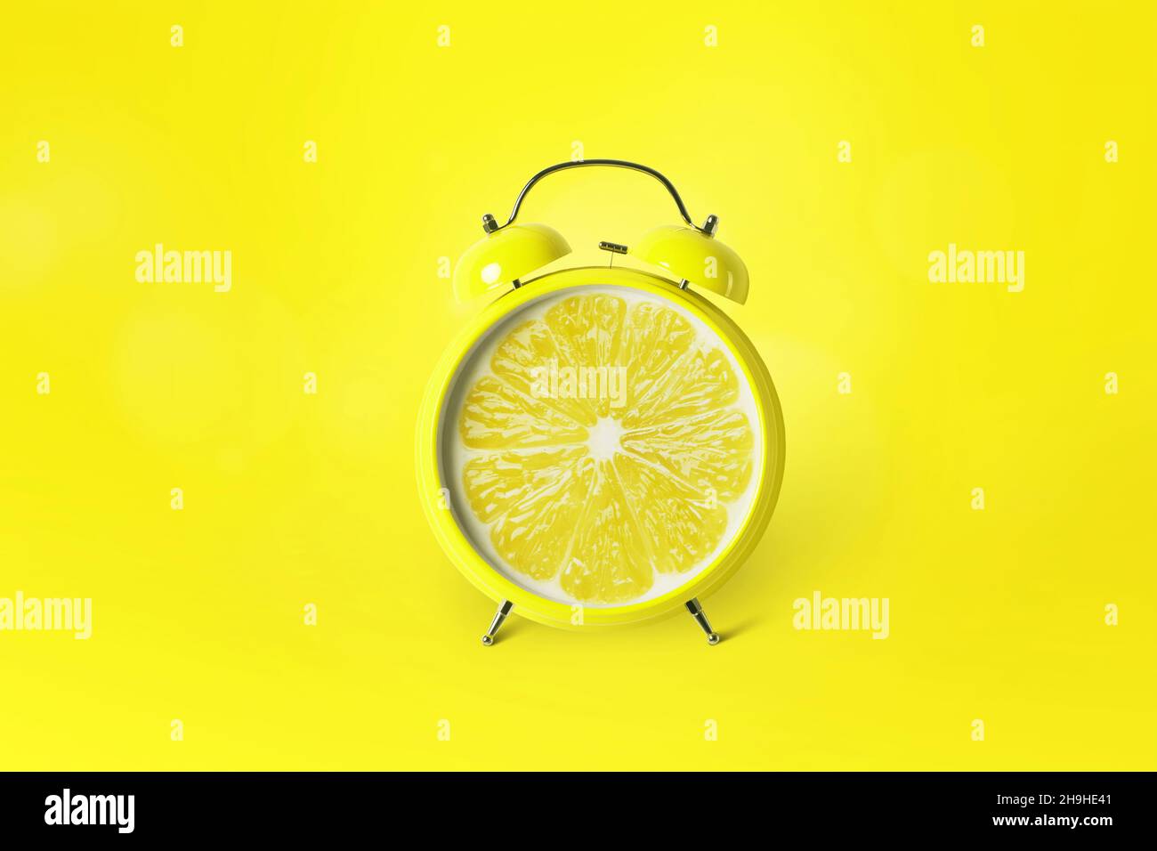 Creative alarm clock citrus fruit lemon on yellow background. Time for ...