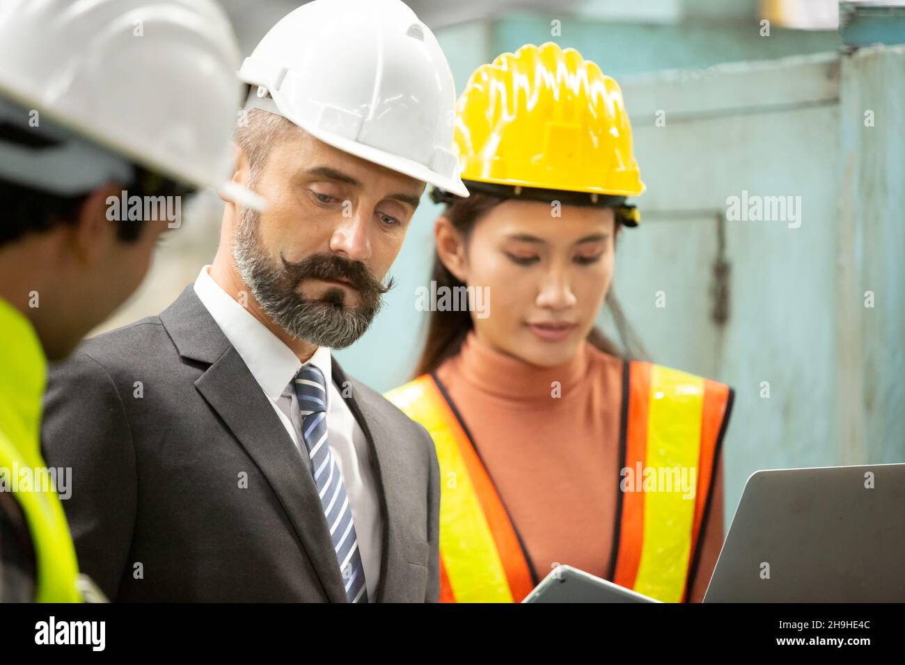 Hard-working engineer holding digital tablet in hands while working in ...