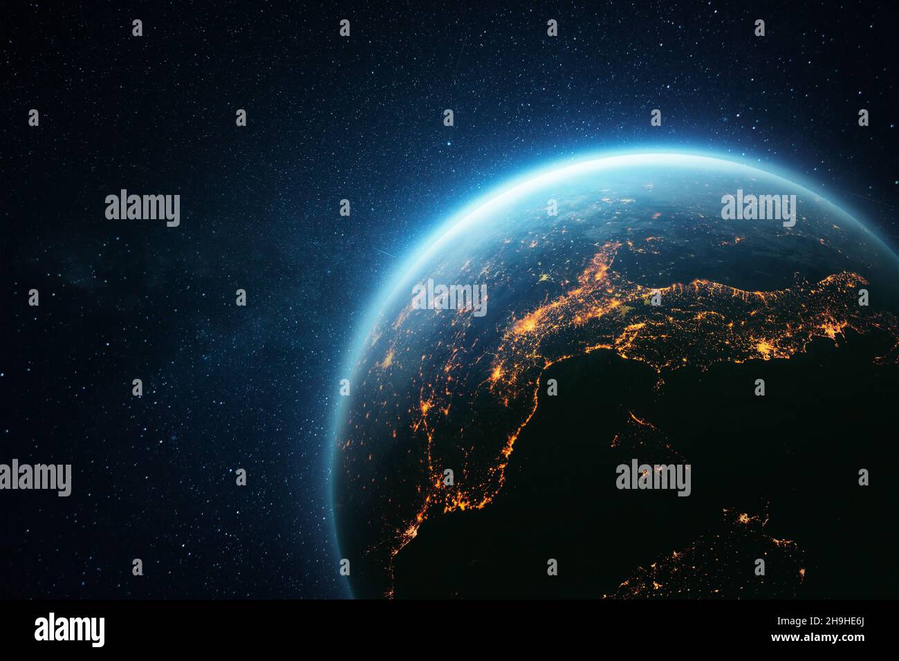 Amazing planet Earth with a blue glow and yellow lights of night cities ...