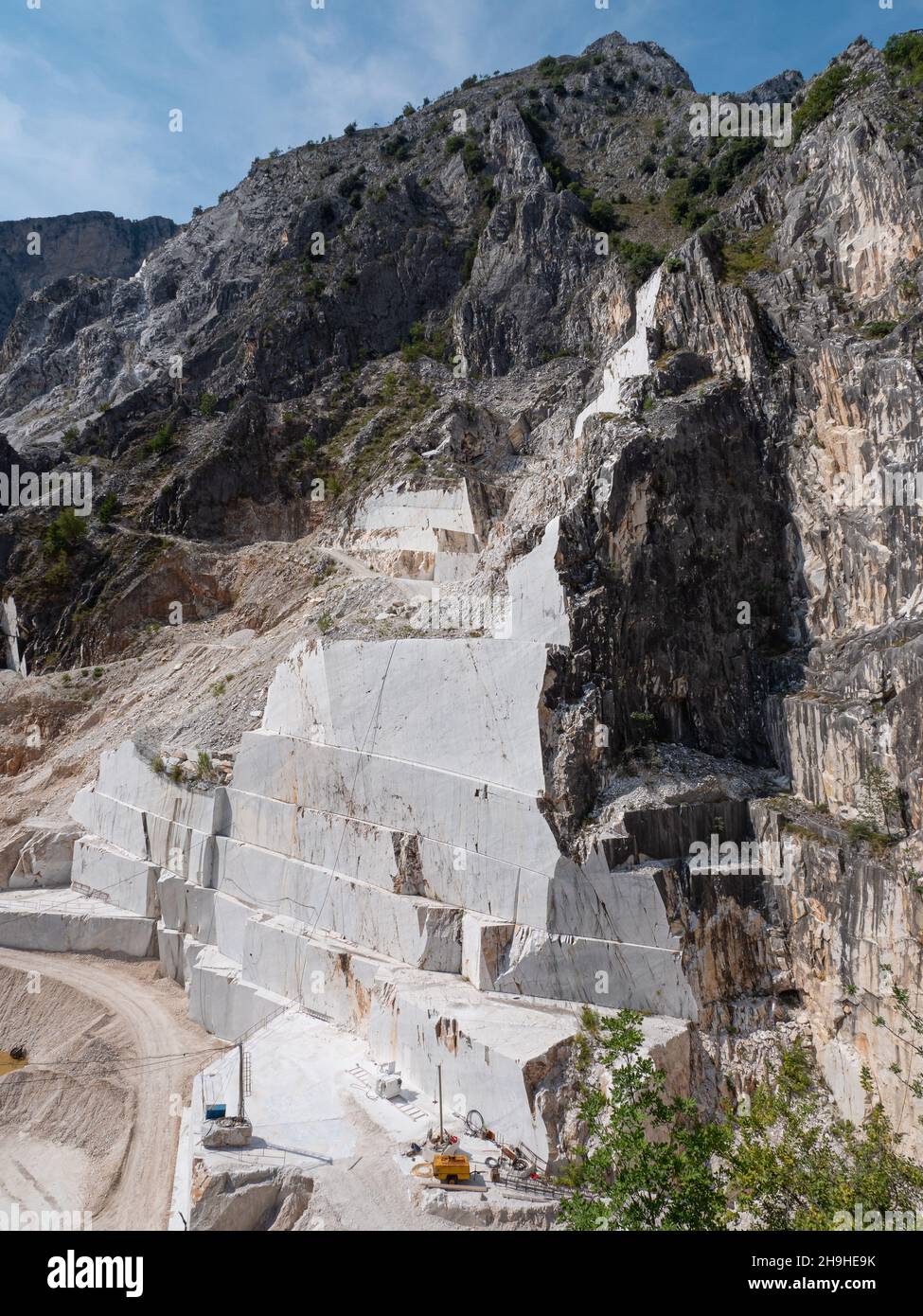 View of the Carrara Marble Quarries with Excavation Vehicles ready for ... View of the Carrara Marble Quarries with Excavation Vehicles ready for ...