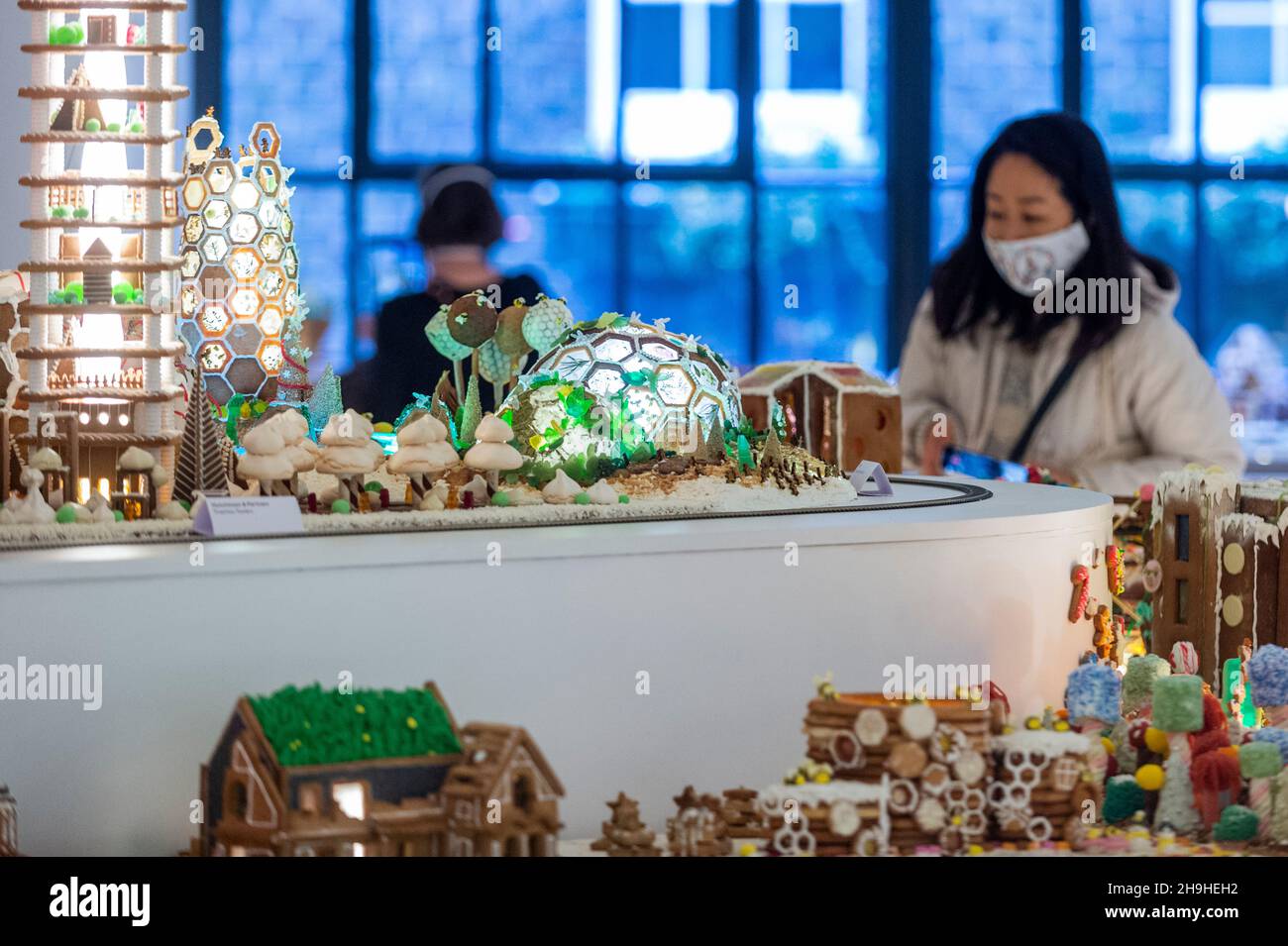 London, UK. 7 December 2021. Visitors view part of The Gingerbread City ...
