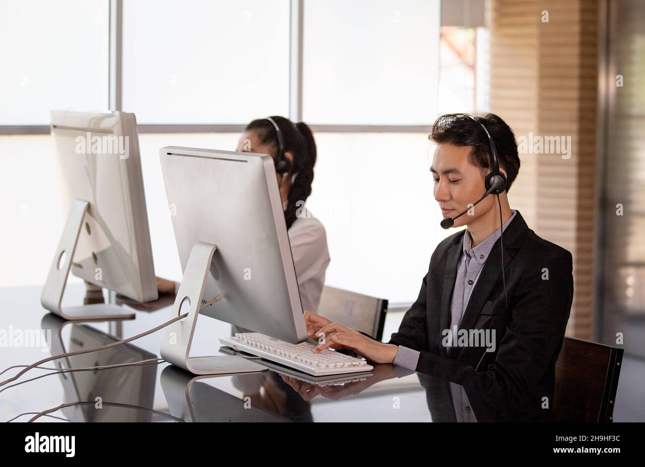 Customer service executive working at office Stock Photo - Alamy