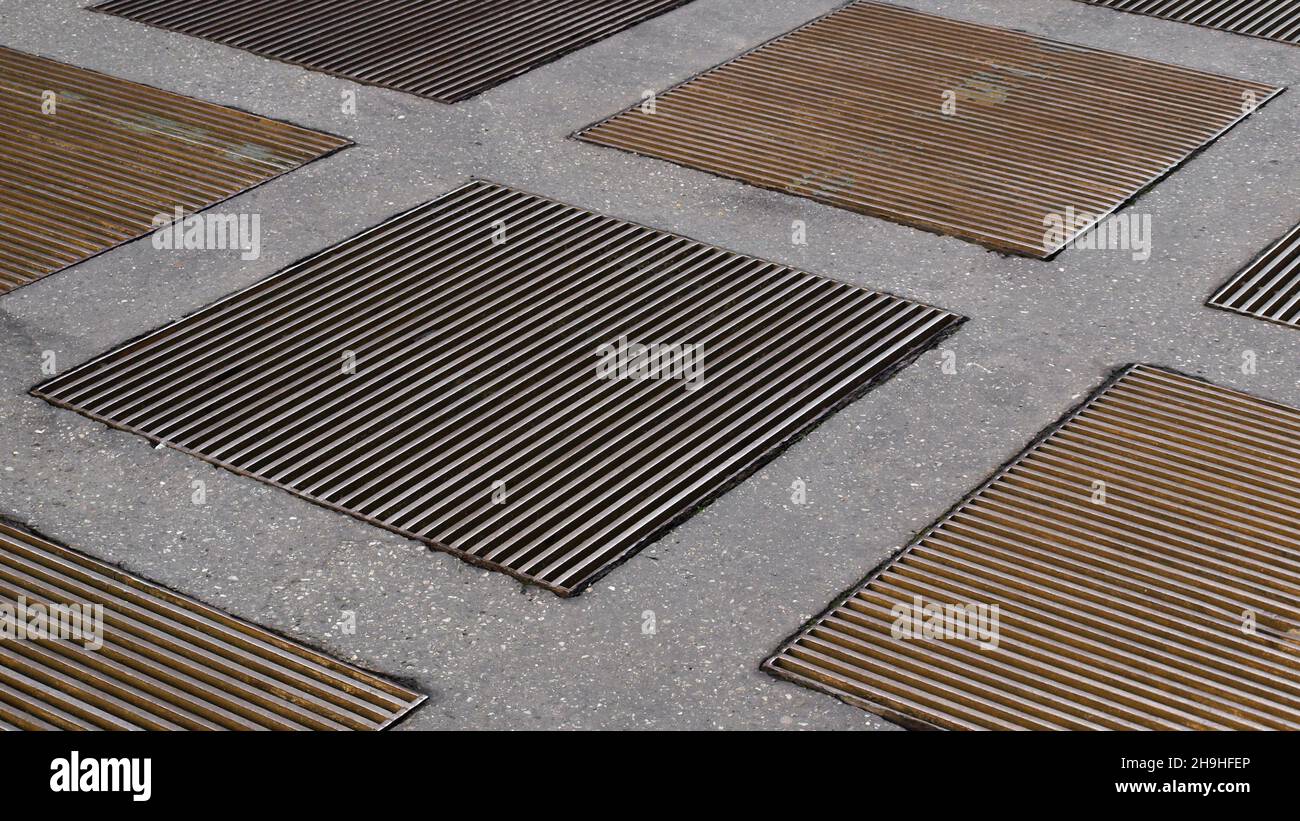 manhole cover grid useful as an industrial background Stock Photo - Alamy