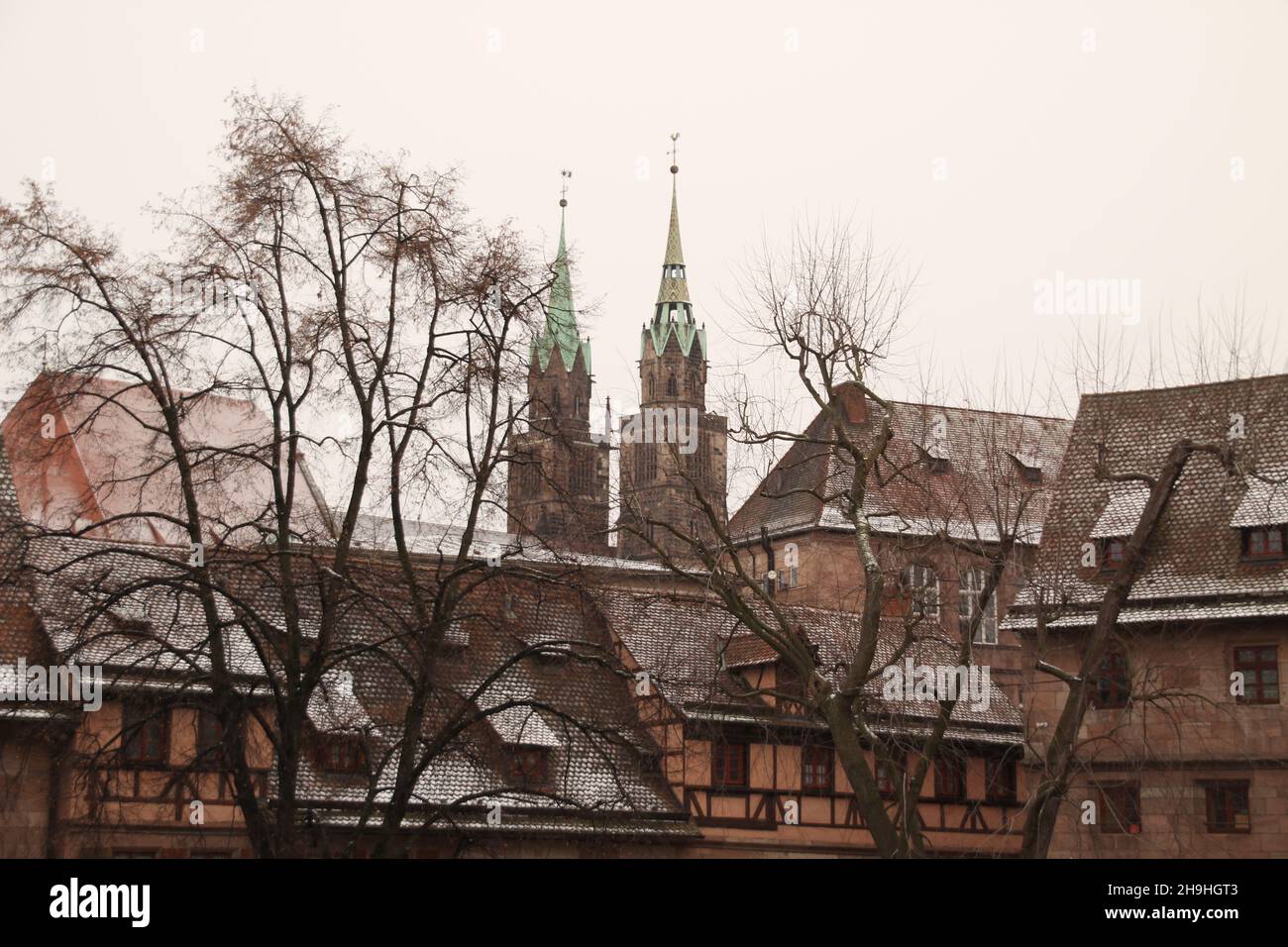 View of beautiful vintage buildings partly covered by snow in Nuremberg ...