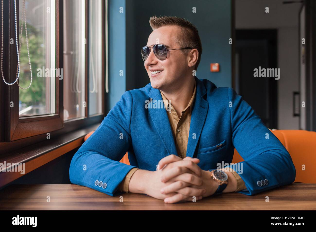 A young positive, smiling businessman of European appearance stylish ...