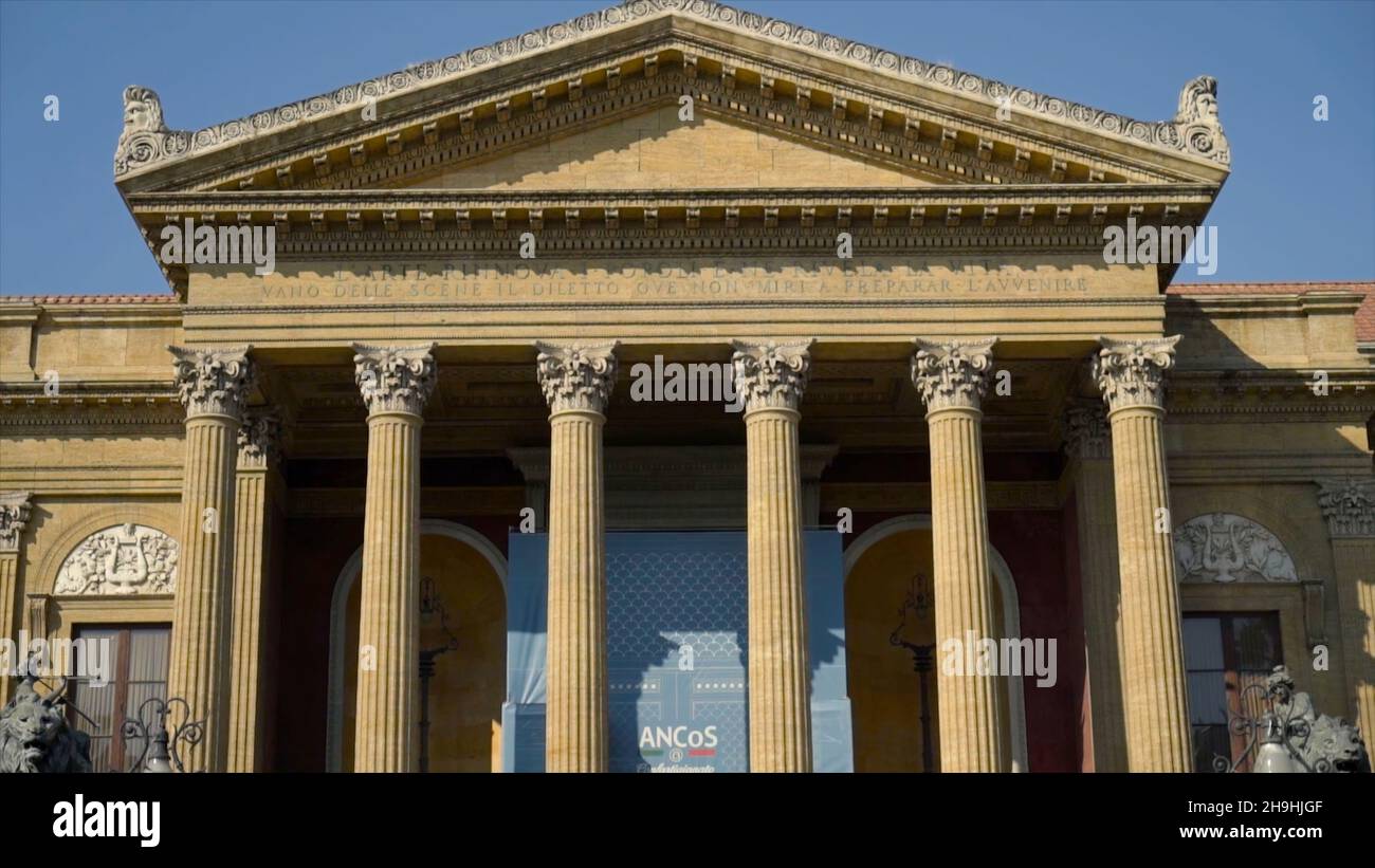 Facade of ancient building with columns and triangular portico. Action ...