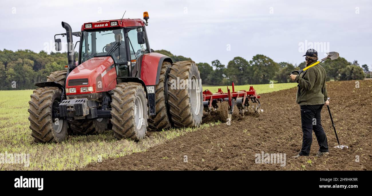 TIRSTRUP, DENMARK - Sep 29, 2021: Female detectorist looking at tractor ...