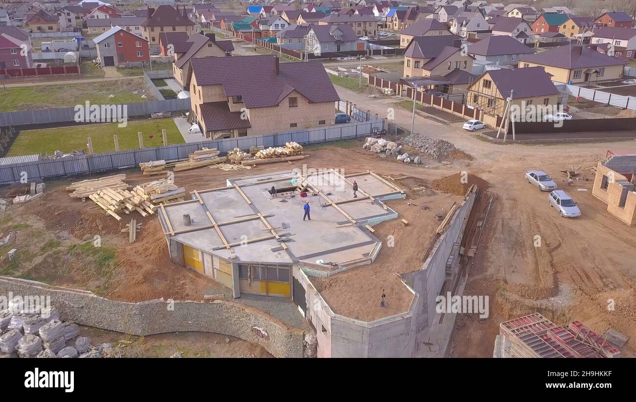 Top view of concrete base of house. Clip. Workers at construction site ...