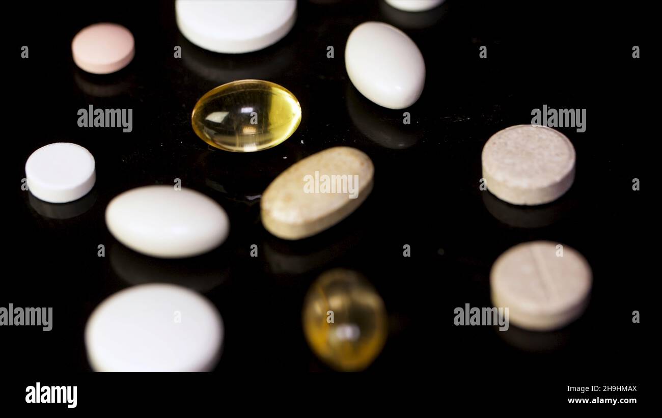 Pills spinning. Pile of several medicines. White tablets with pills on ...