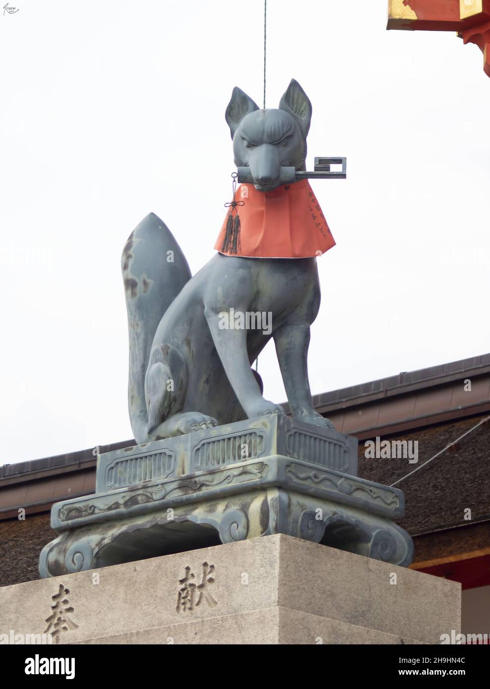 Vertical shot of a statue of fox in the temple of goddess Inari in ...