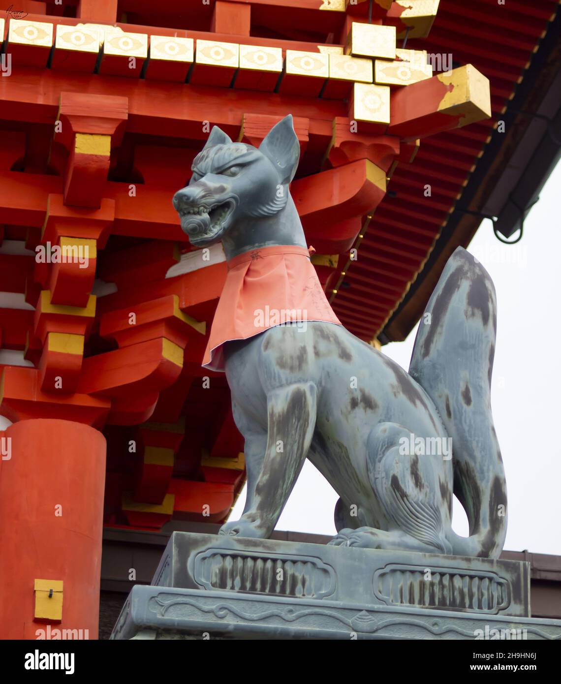 Vertical shot of a statue of fox in the temple of goddess Inari in ...