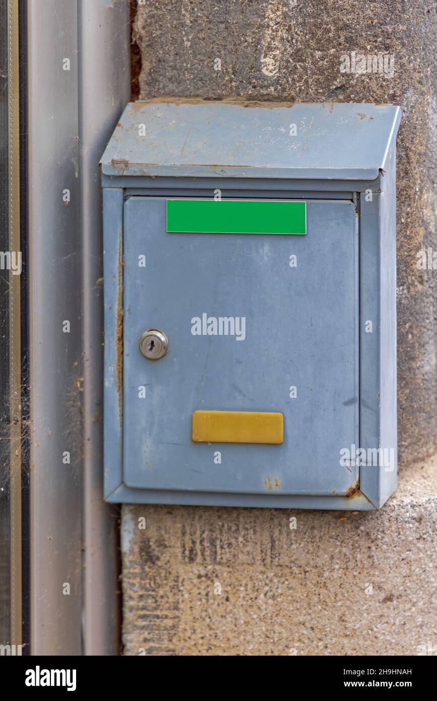 Wall Mounted Mailbox With Green Name Tag Stock Photo - Alamy