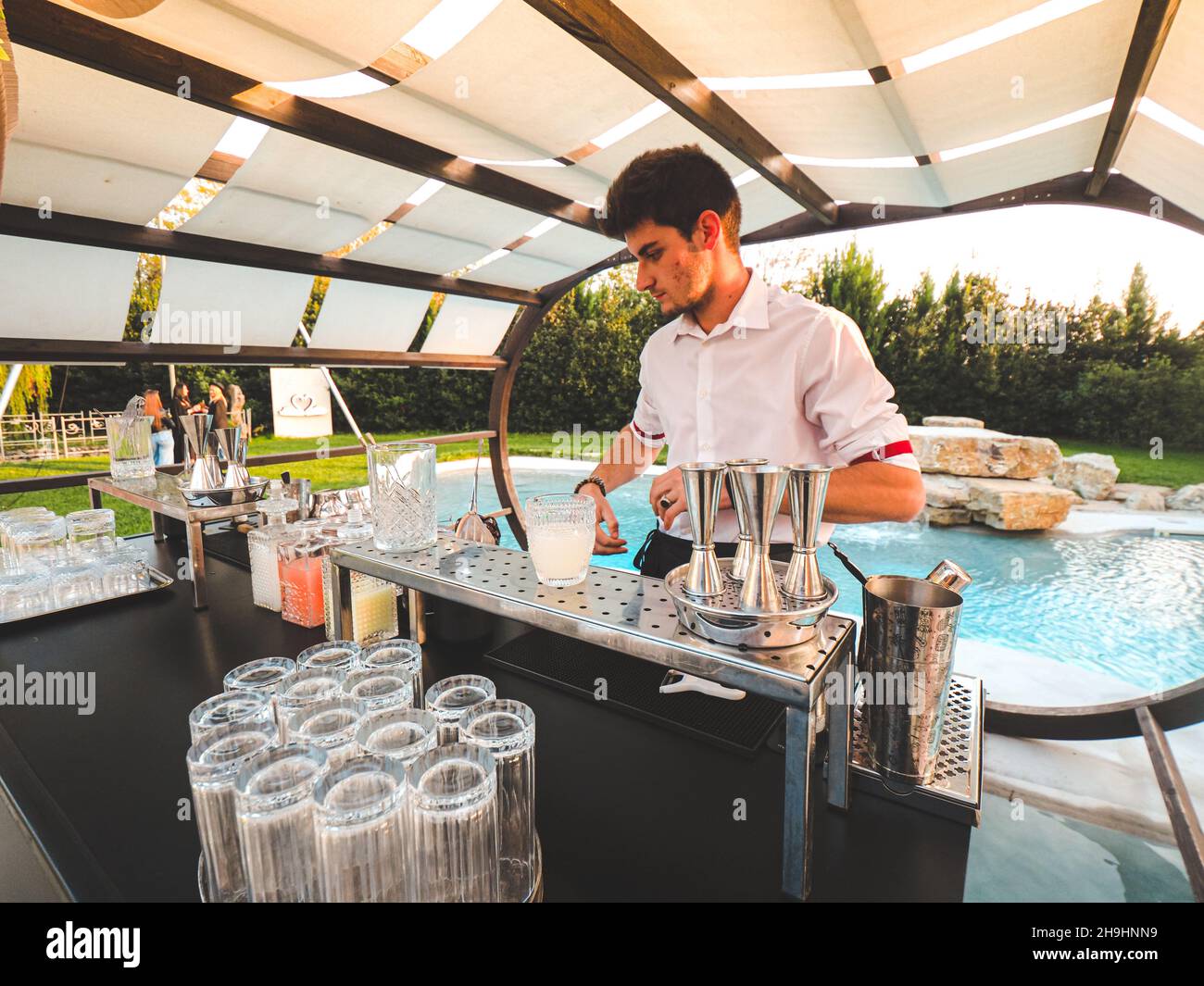 Barman using bar equipment at the pool party Stock Photo - Alamy