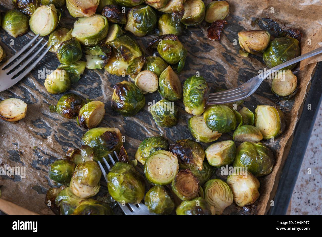 oven baked sliced brussels sprouts on baking tray closeup Stock Photo ...