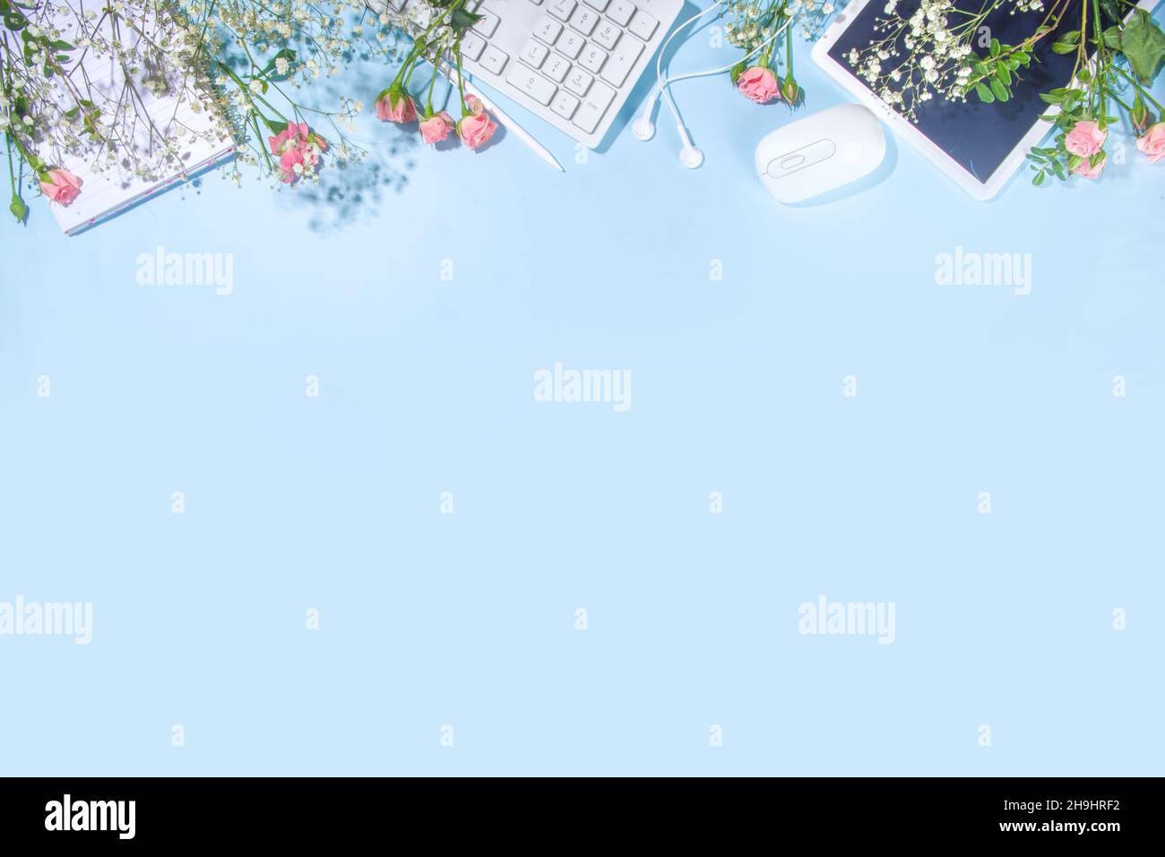 Spring office desk flatlay with keyboard, notepad, tablet, mouse ...