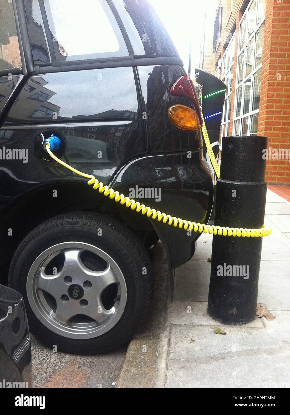 An electric car being charged by the roadside Stock Photo - Alamy