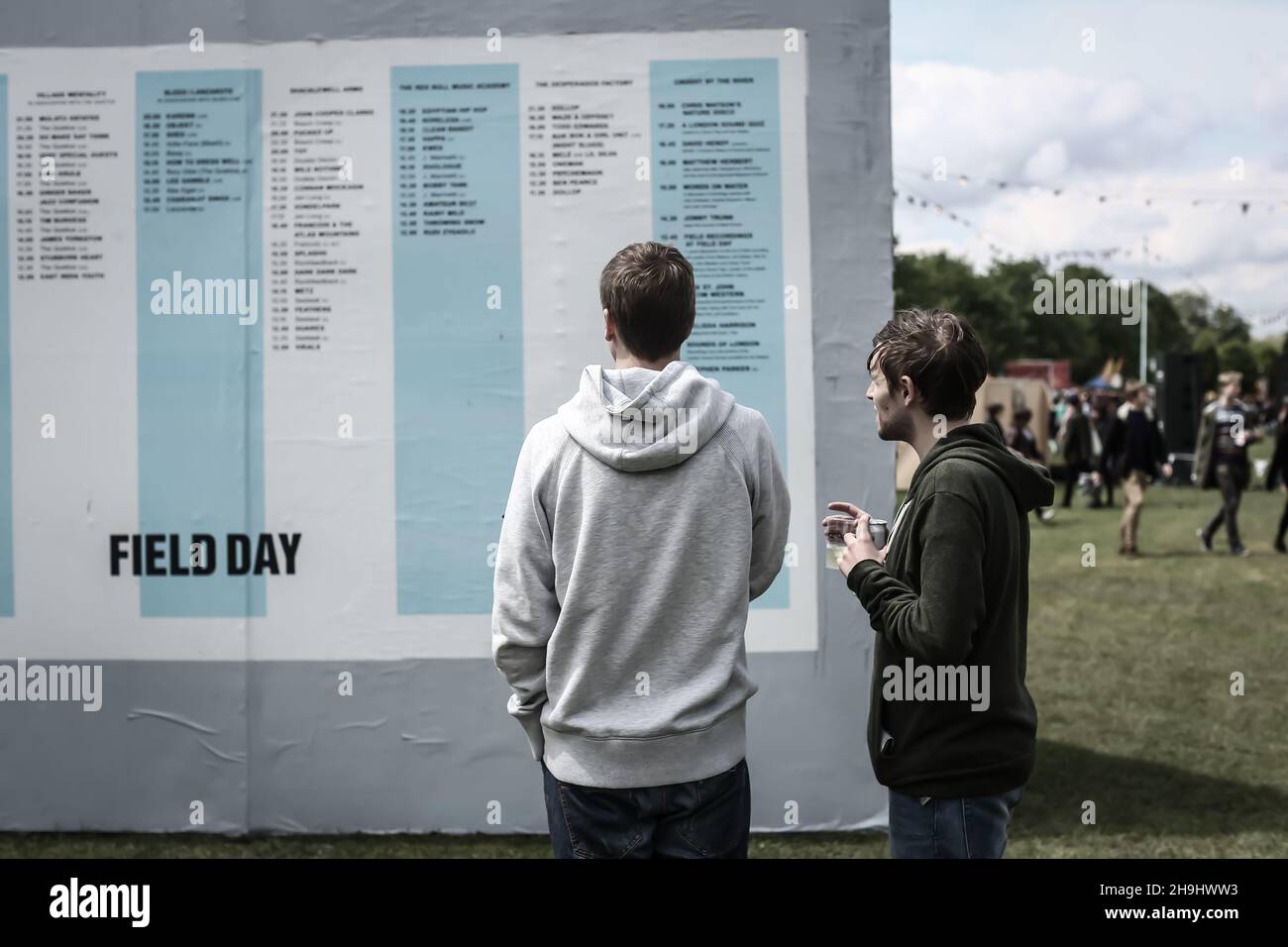 Festival goers check out the stage times at the Field Day Festival in ...