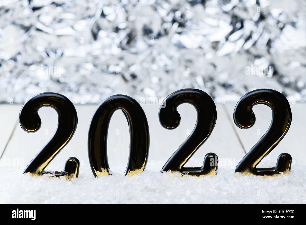 Black numbers 2022 on white background with snow. New year backdrop ...
