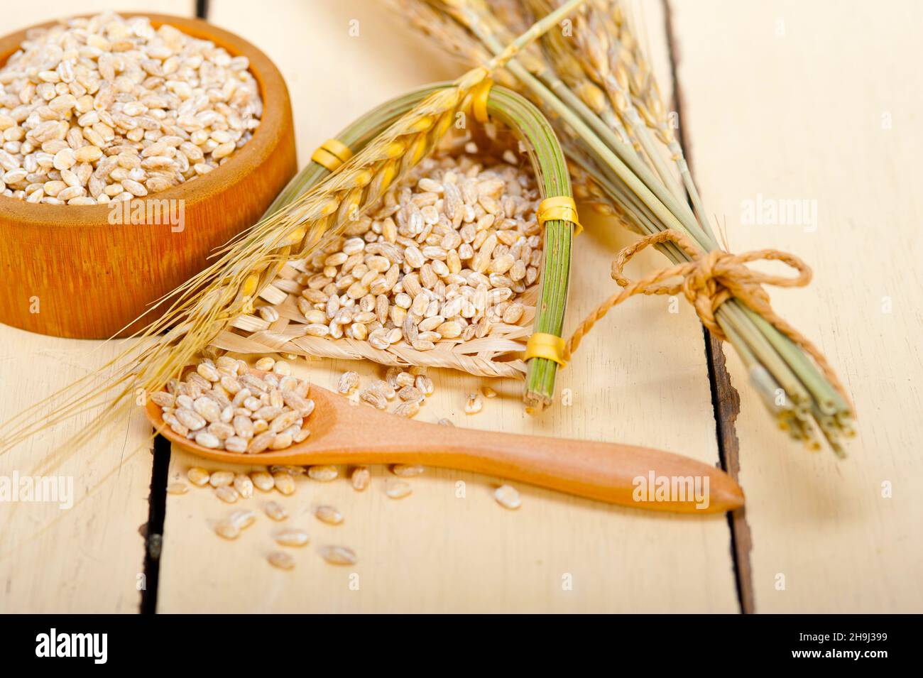 organic wheat grains over rustic wood table macro closeup Stock Photo ...