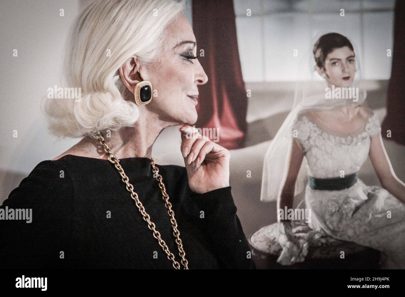 Carmen Dell???Orefice poses for photos next to a photo of herself taken ...
