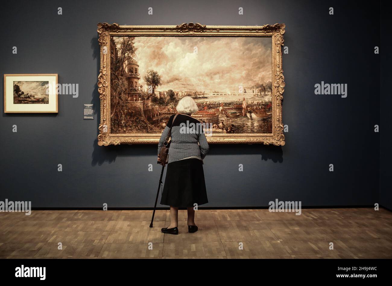 A woman looks at Constable's The Opening of Waterloo Bridge seen from ...